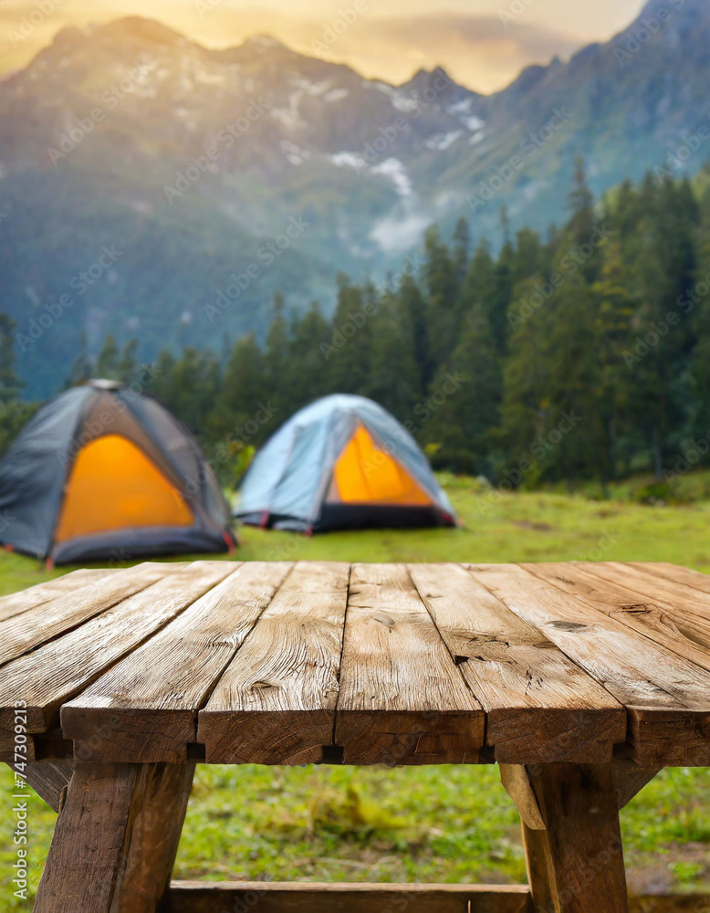 Wooden table in the blur camping tent at sunset in the mountain. Cool ...