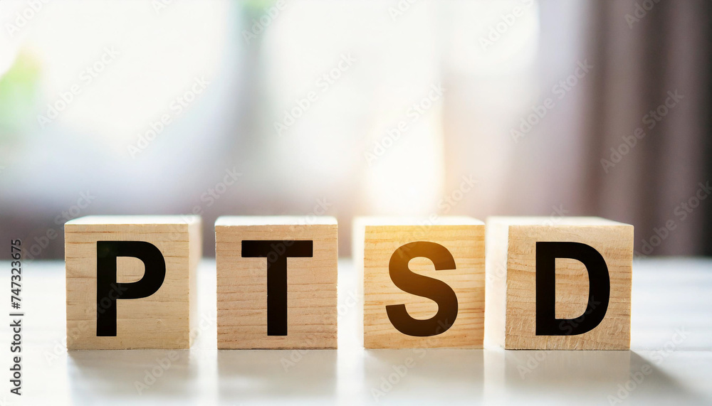 Wooden blocks spell 'PTSD' on white table, symbolizing trauma recovery ...