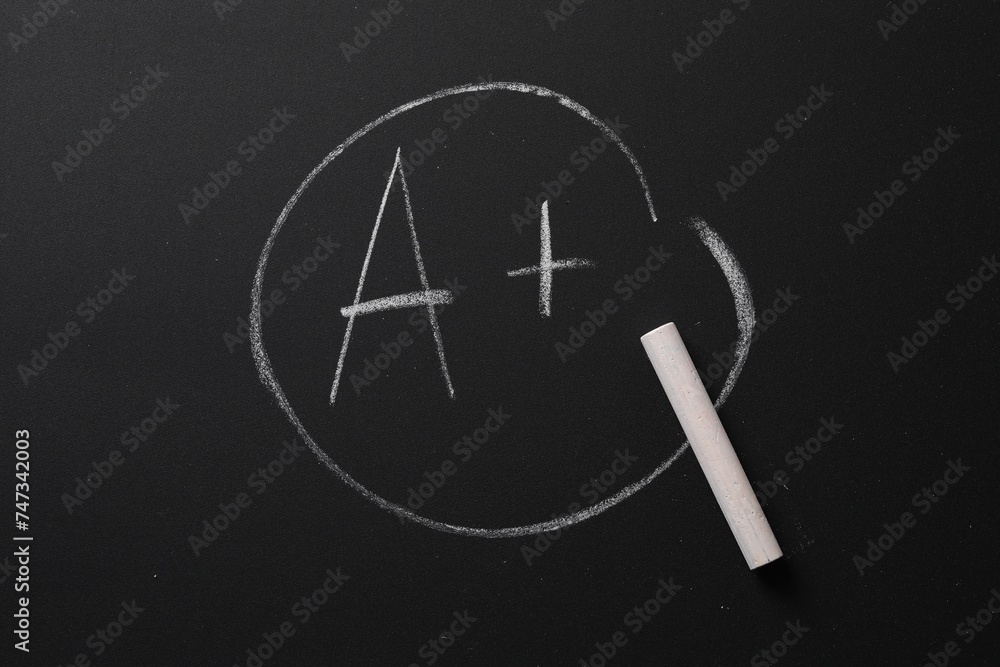 School grade. Letter A with plus symbol and chalk on blackboard, top ...