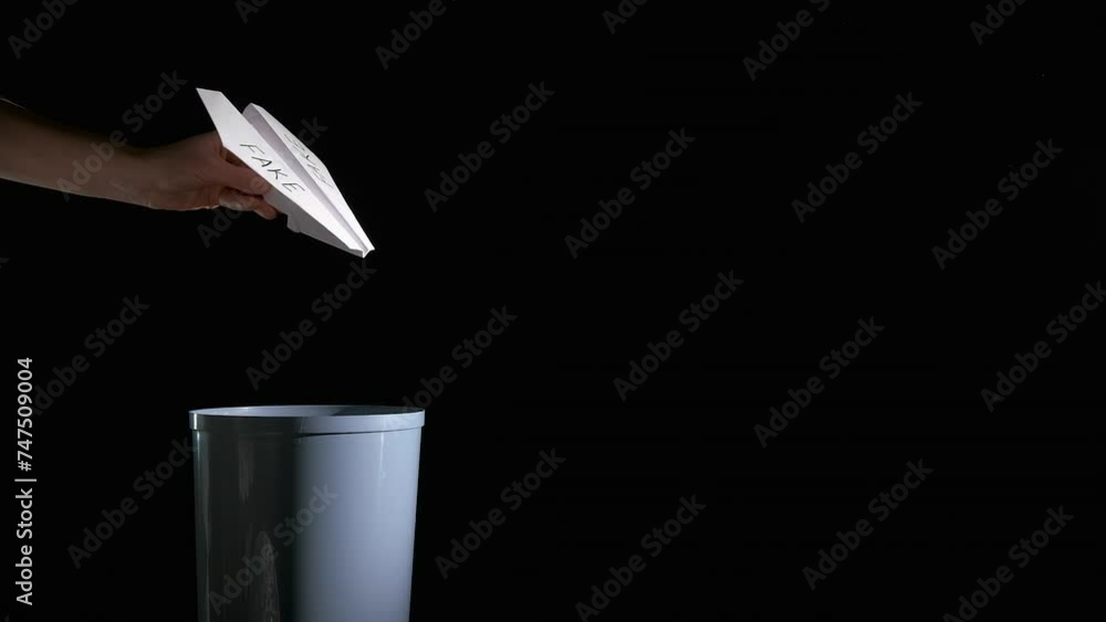 Throw fake news. A woman hands throw the paper plane with fake into the ...