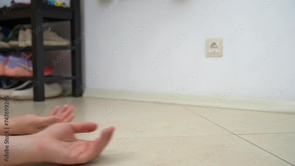 Unconscious man lies hand raised up dragging along floor Dead body is ...