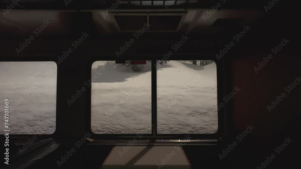 Train window view of snowbanks rolling by in a hilly, snowy forest. The ...