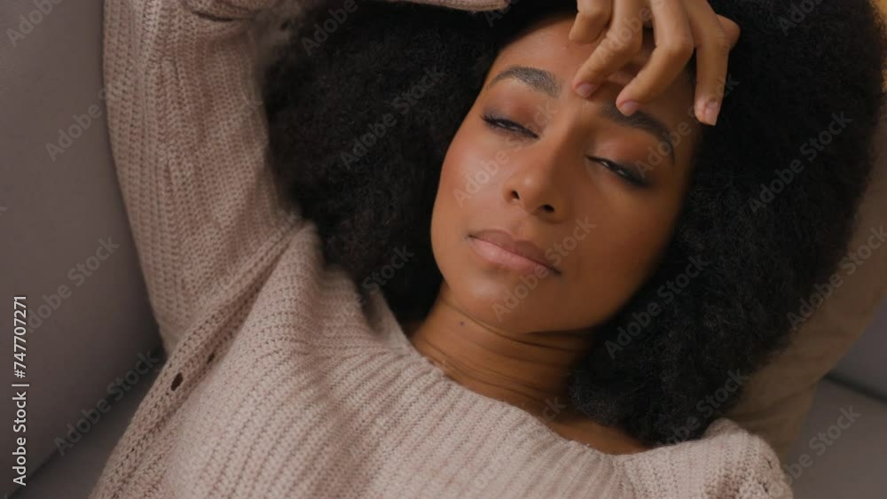 Lonely sad depressed African American woman lying on couch alone at ...