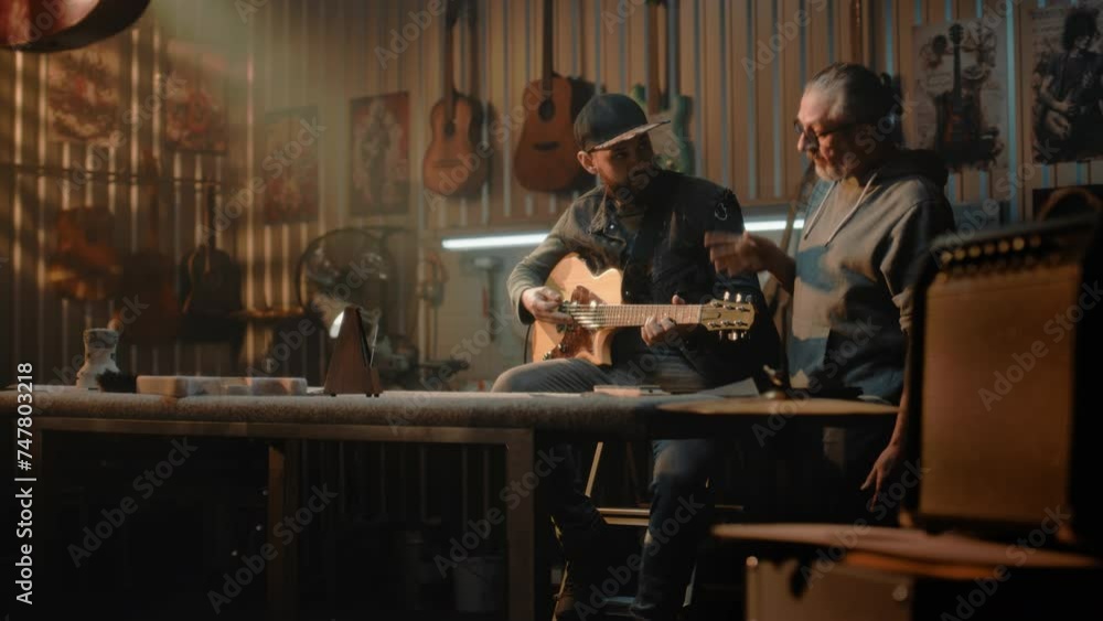 Video „Male musician plays guitar in modern garage studio listening to ...