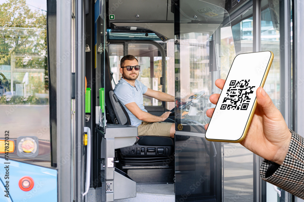 Qr-code on phone screen in front of bus driver. Digital ticket for ...