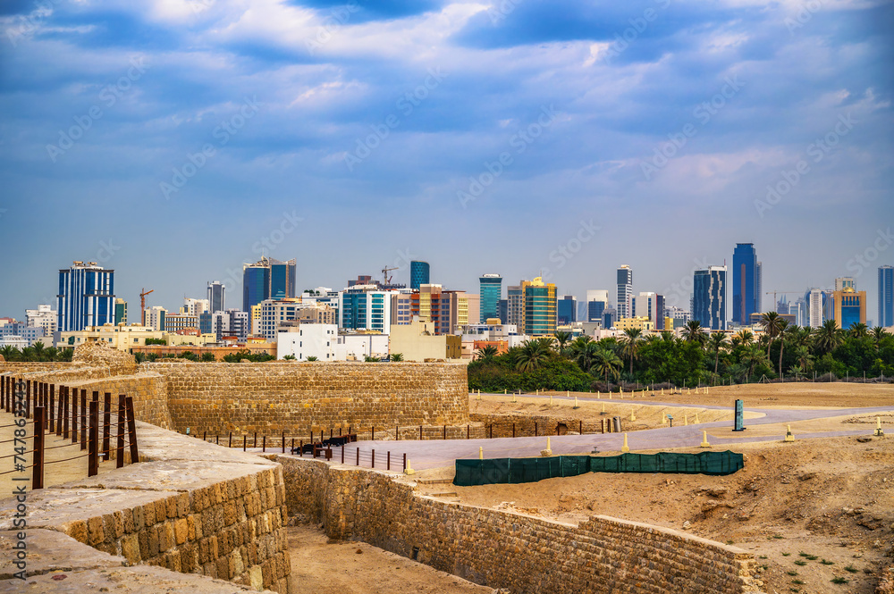 Manama skyline behind ancient Bahrain Fort. Manama, the capital city of ...
