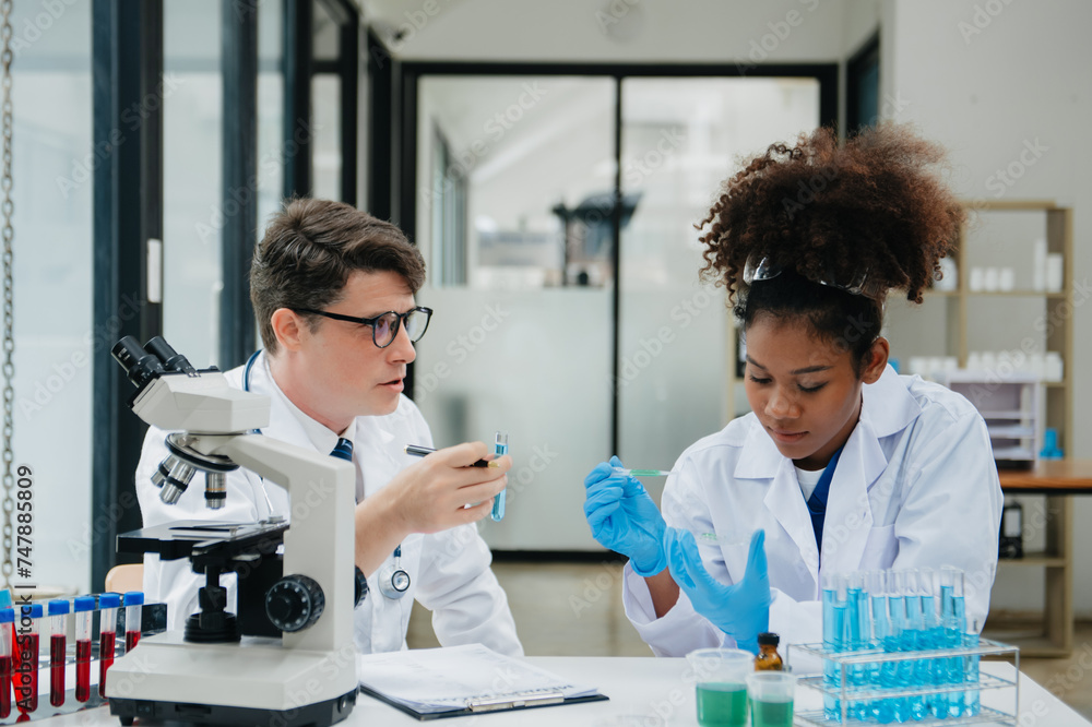 Scientist two man and woman with tablet and laptop, laboratory and ...