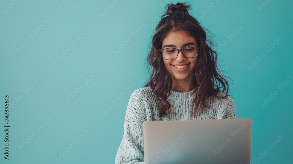 An attractive young latina woman using her laptop device. A picture of ...