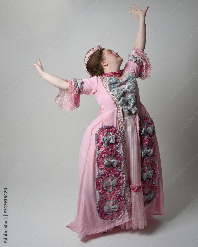 Full length portrait of woman wearing historical French baroque pink ...