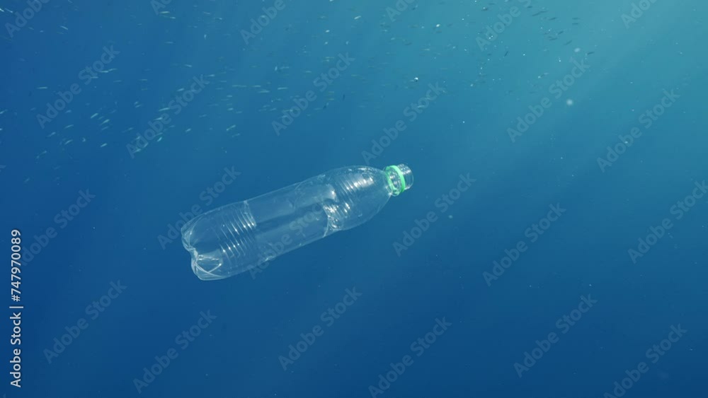 Plastic bottle slowly flowing last bubbles of air and it sinks into ...