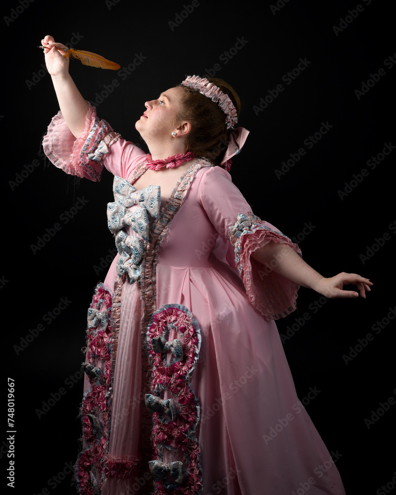 portrait of female model wearing an opulent pink gown, costume of a ...