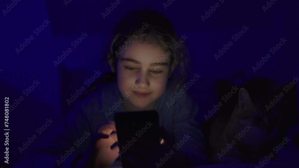 Child Using Mobile Phone Evening at Home. Teen Girl Watching Online ...