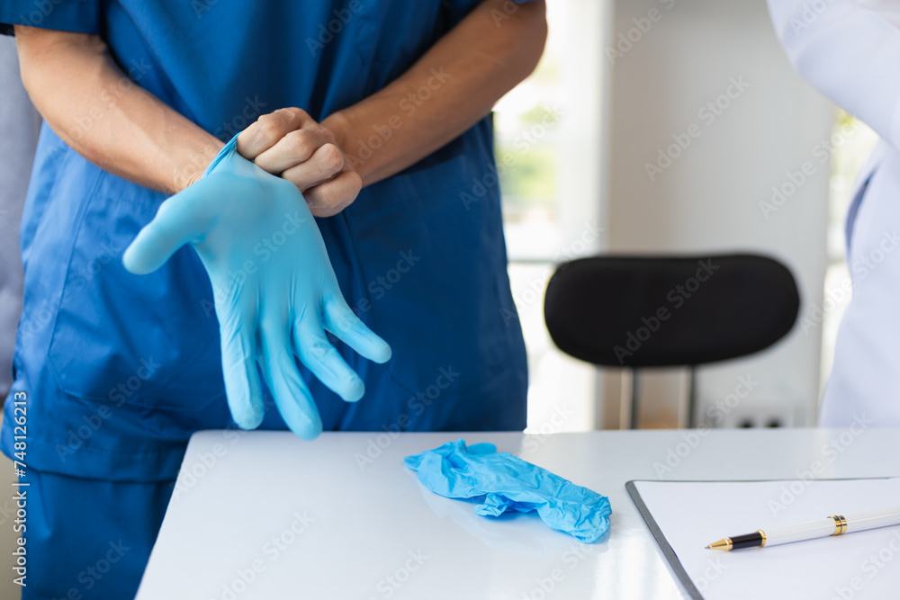 doctor is wearing blue rubber gloves prevent direct contact with ...