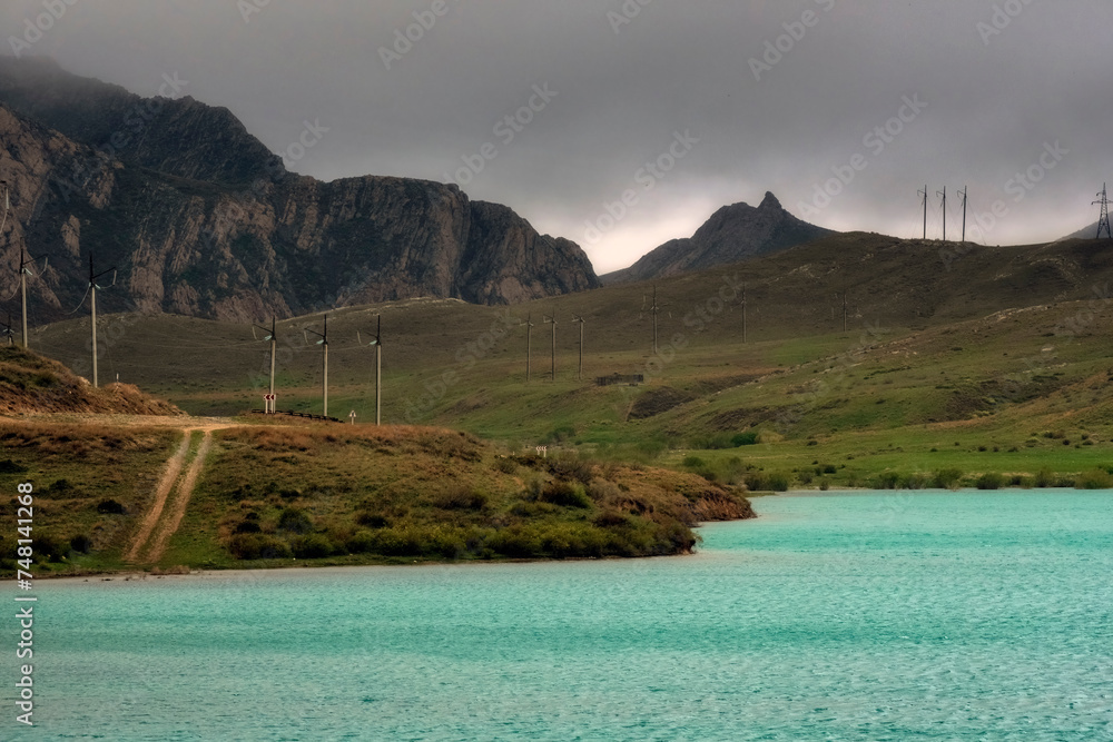 road along lake or reservoir with beautiful turquoise water in the ...