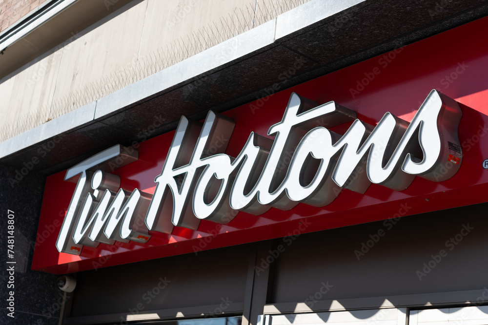 exterior facade and sign of Tim Hortons, a coffee shop chain, here ...