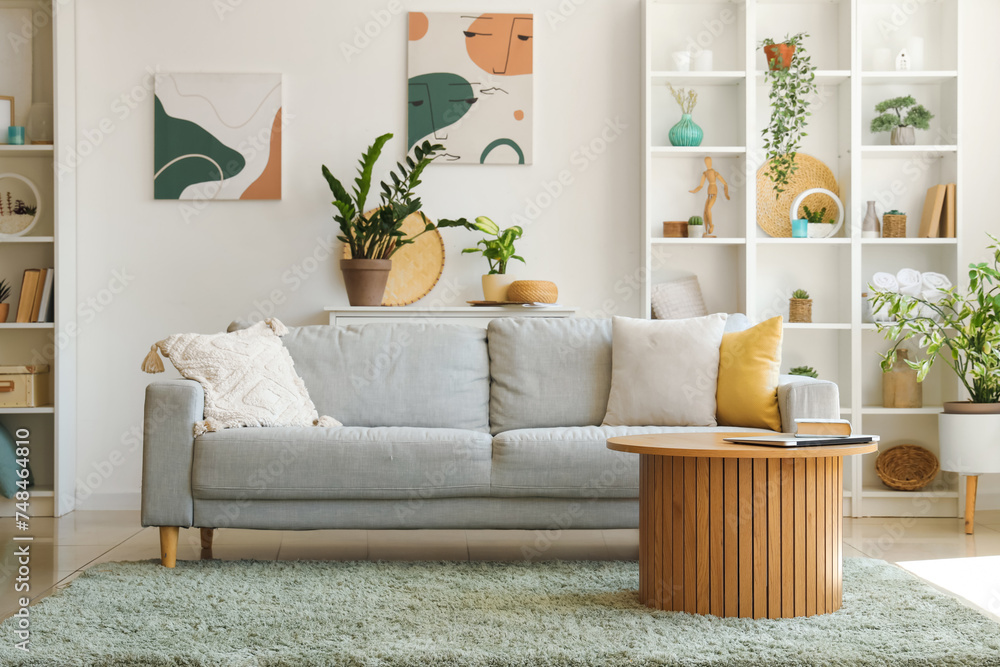 Interior of light living room with sofa, table and houseplants Stock ...