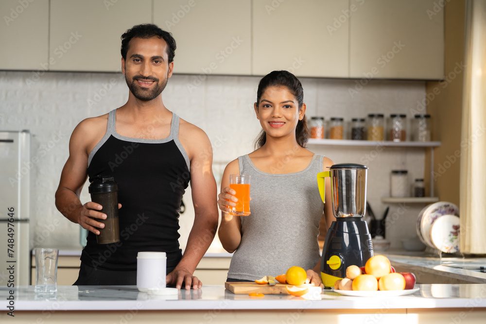 Portrait shot happy active couples with Protein shaker bottle and wife ...