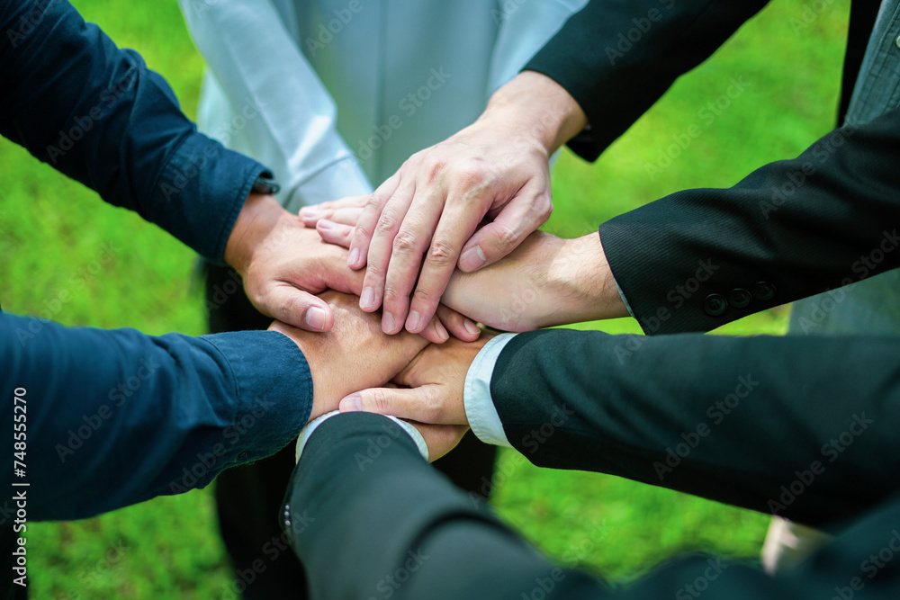green business team young people putting their hands together ...