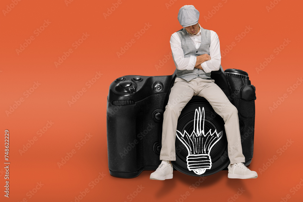 Young professional male photographer having lack of bright ideas ...