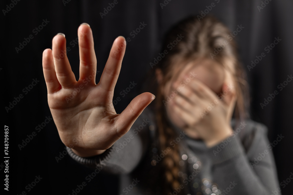 Child violence and abused concept. Little girl sitting in a dark room ...