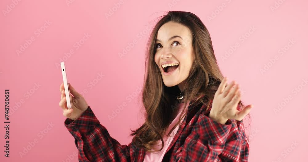 Brunette woman stand side look surprised wow hold using mobile cell ...