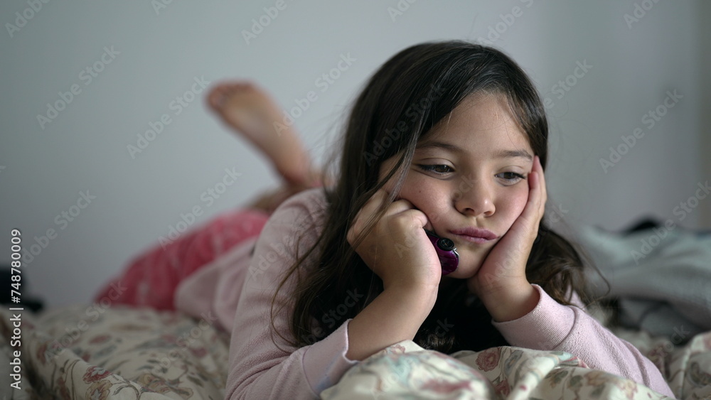 One bored little girl feeling extreme boredom with nothing to do laid ...