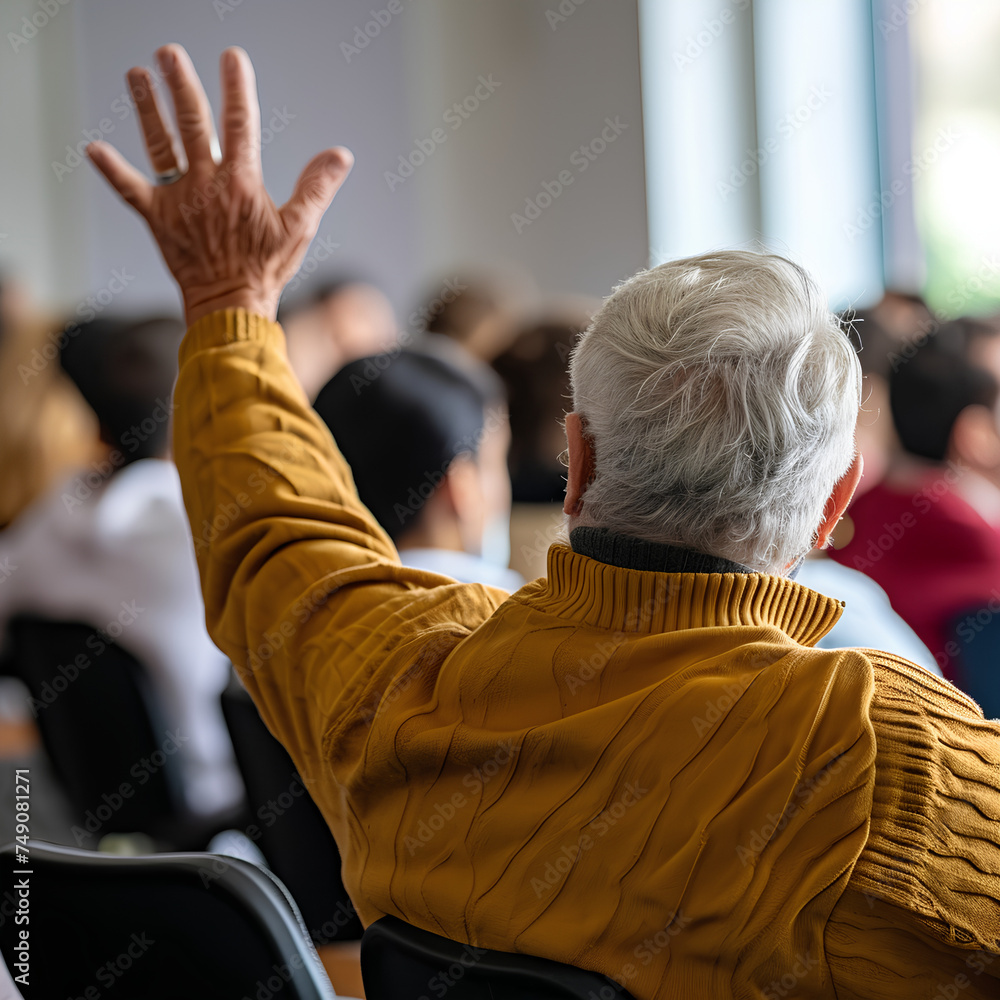 Back view of older student, Back view of older student raising his hand ...