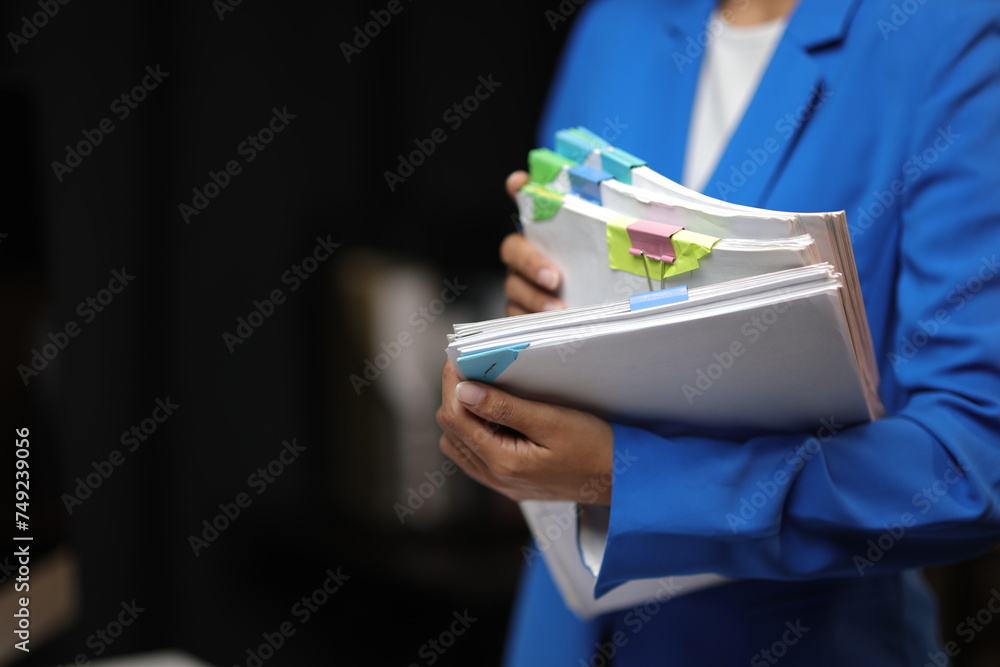 Businesswoman hands working in Stacks of paper files for searching and ...