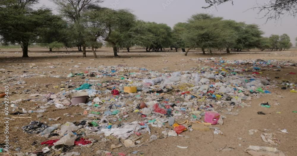 Panning. Horrific plastic pollution in a dried out riverbed. Climate ...
