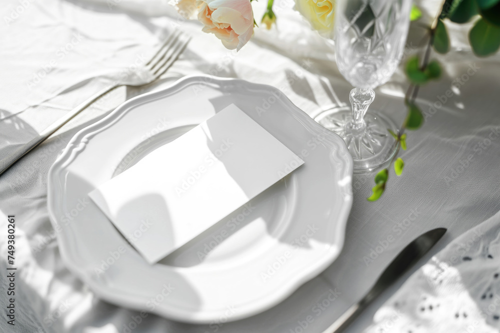 Romantic dining table setting with empty white card mockup on the plate ...