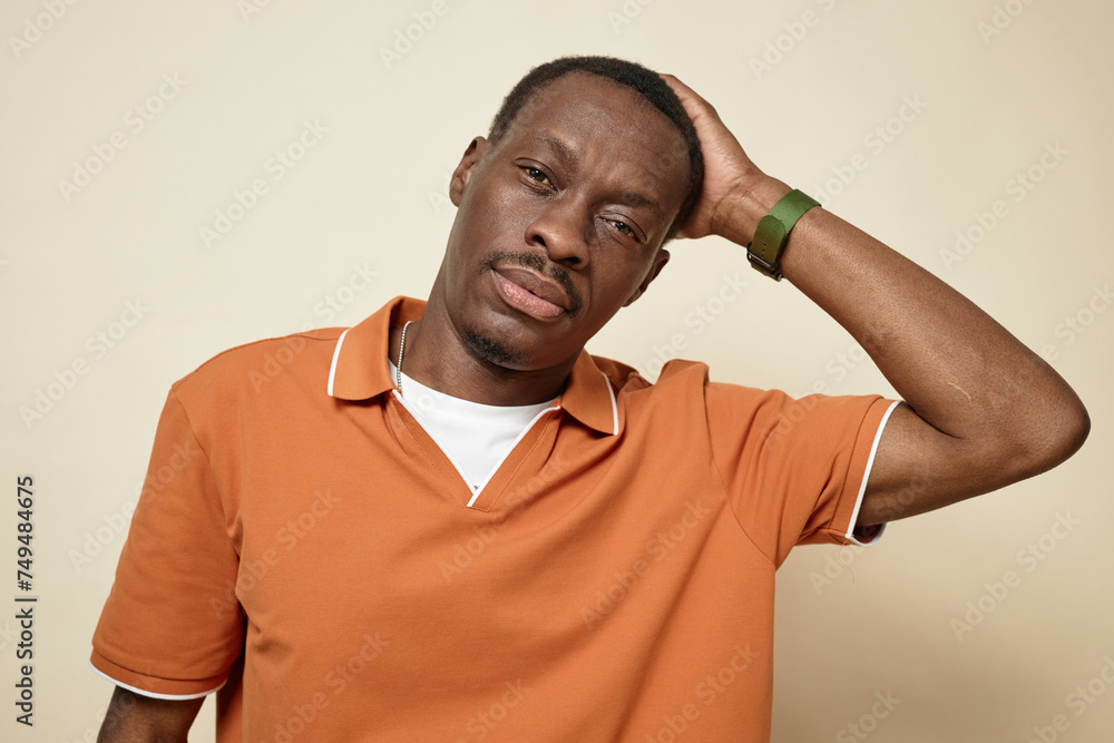 Portrait of Black adult man touching head with no hair in studio and ...