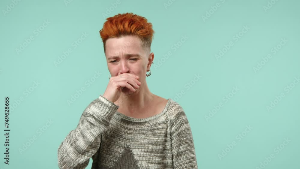 A lesbian woman appears visibly upset and crying, hand covering her ...