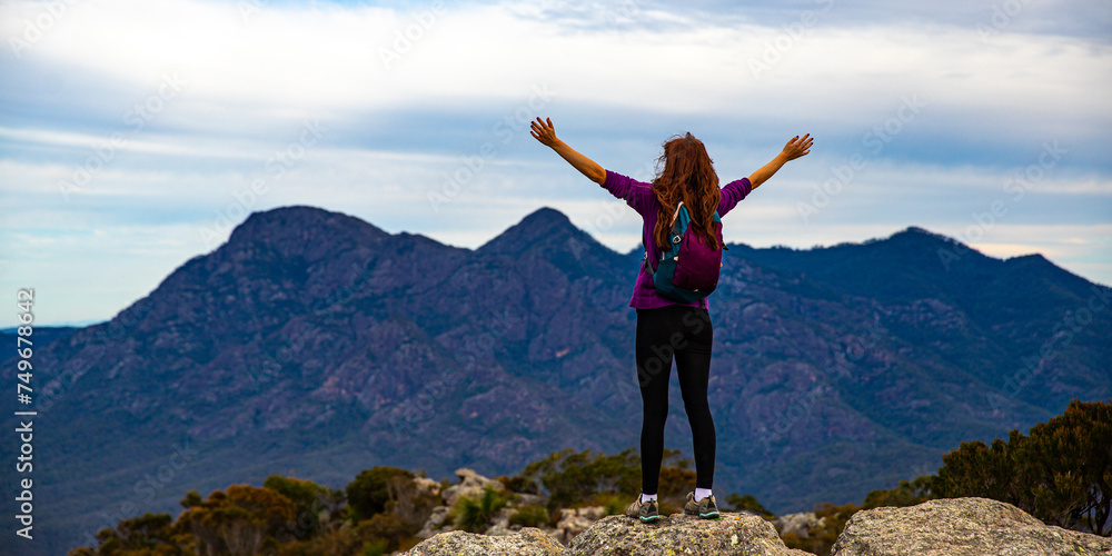 Foto de backpacker girl celebrating successful hike to the summit of ...