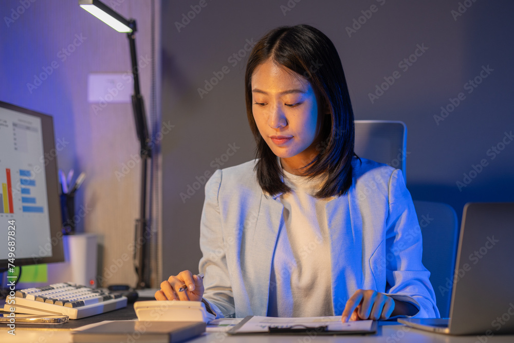 An employee is sitting in a personal office doing work assigned by a ...