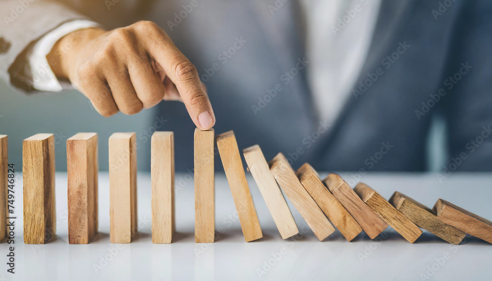 Wooden Dominos halted mid-fall, preventing coin stack collapse on clean ...