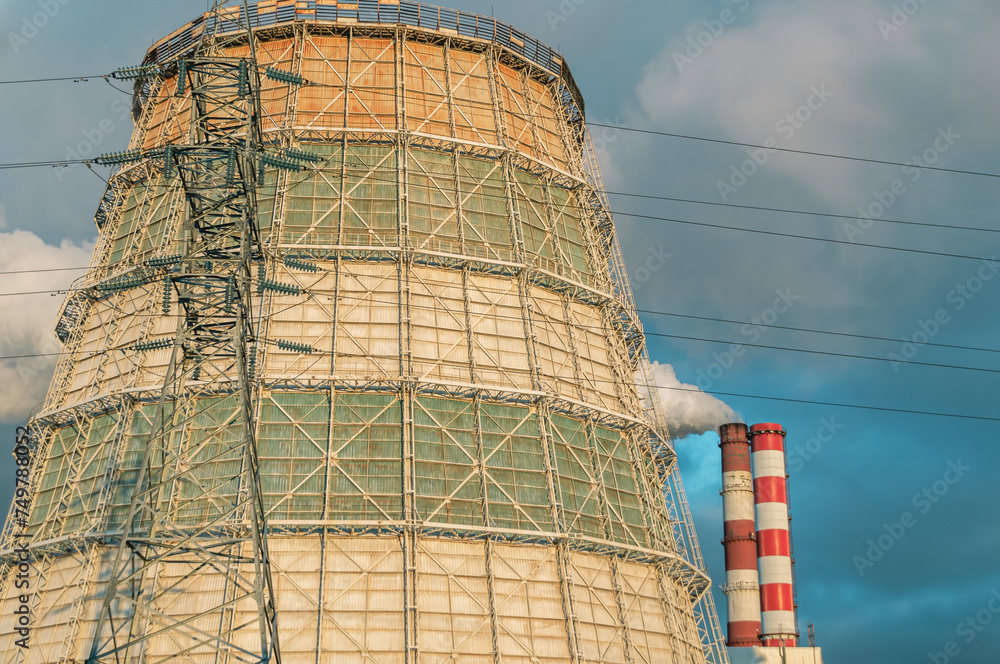 Large cooling towers of thermal power plants. White steam comes out of ...