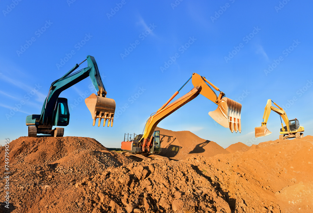 Excavator works on a construction site during excavation work against a ...