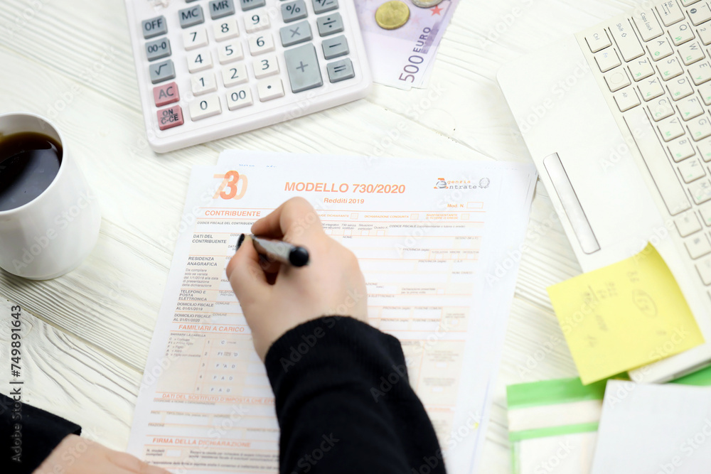 KYIV, UKRAINE - OCTOBER 31, 2023 Accountant fill italian tax form ...