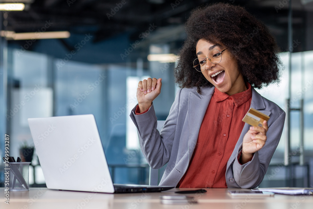 An exuberant young businesswoman celebrates a successful transaction or ...