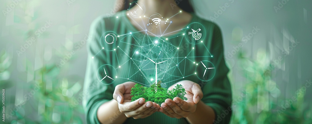 Businesswoman hand-holding green energy icons with a sustainable ...