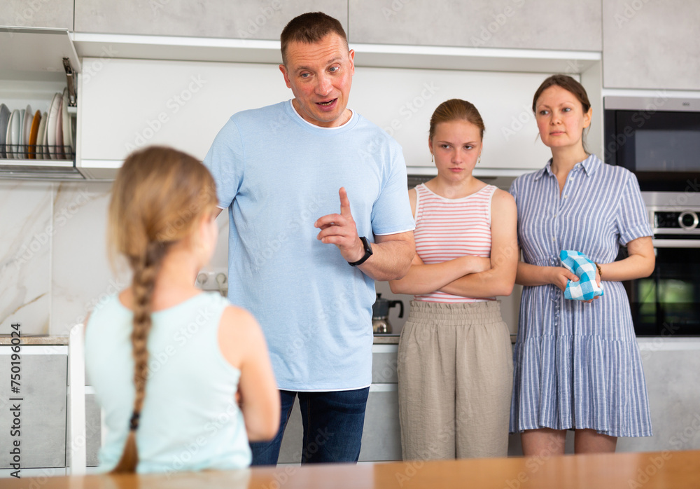 Family scene in kitchen, unpleasant conversation. Girl with hair in ...