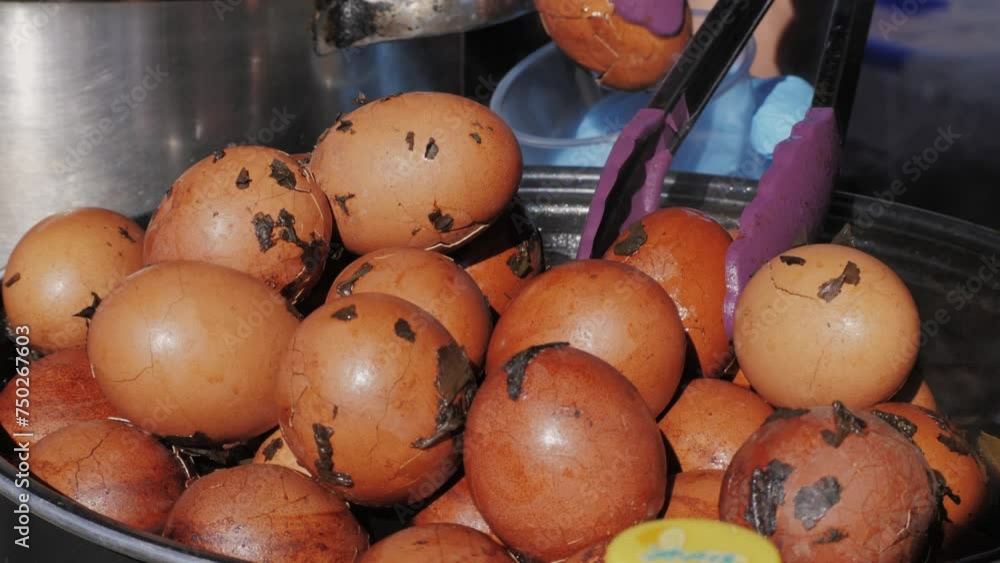 Chinese century eggs or tea egg in boiling water close-up. Chinese egg ...