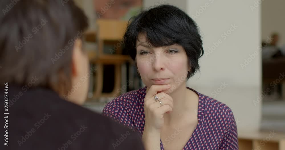 Dialogue. Woman nods during the conversation, displaying active ...