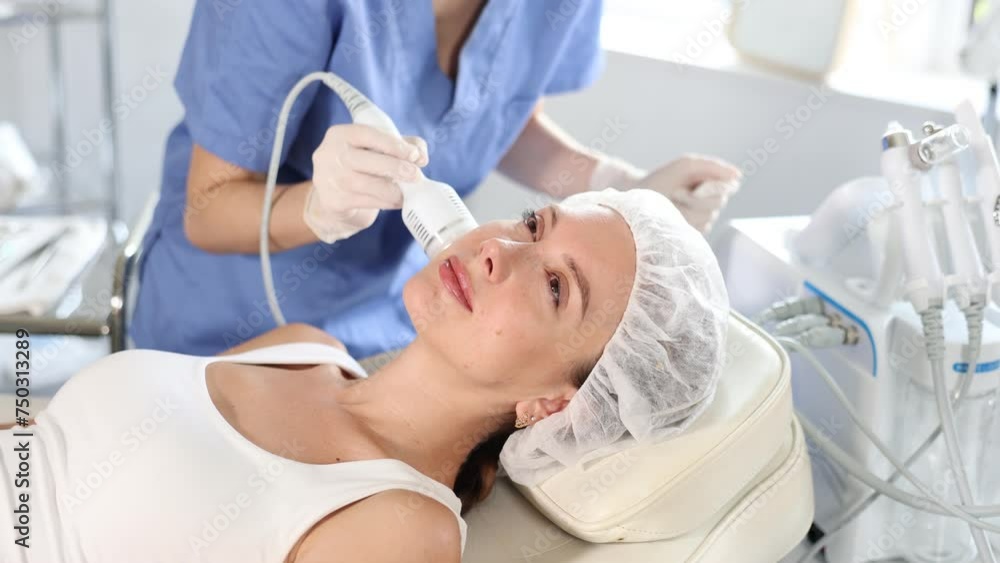 Young woman undergoing hardware facial treatment using cold hammer ...
