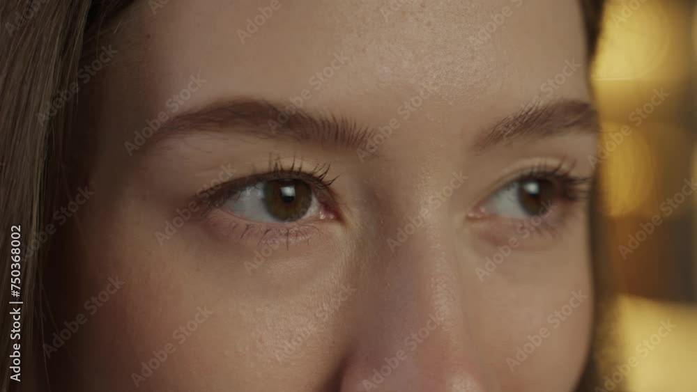 A close-up capture reveals the delicate features of a young womans eyes ...
