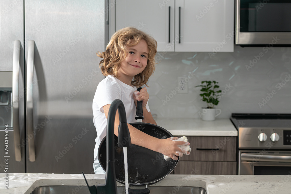 Child boy washing dishes in the kitchen interior. Clean washed dishes ...