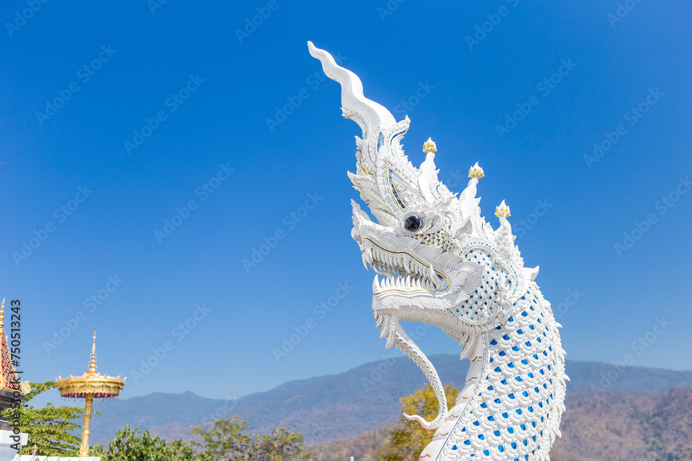 White naga head sculpture with space on clear blue sky background ...