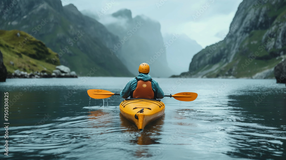 Kayaking into the Misty Mountains, A kayaker in vibrant gear paddles ...