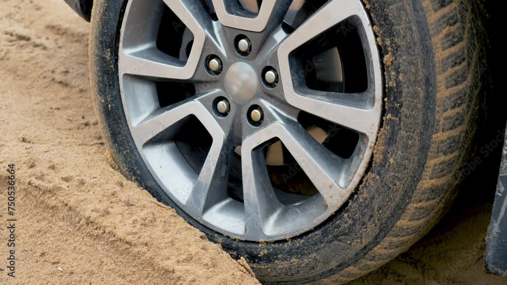 Stockvideo Car big wheels spin and spit up heavy wet sand as unknown ...