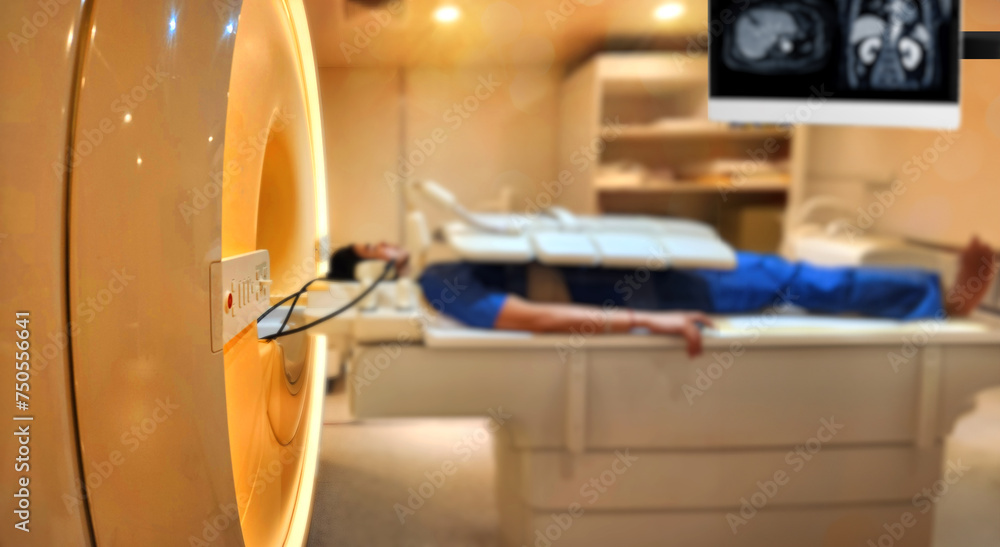 A patient lies down comfortably on the MRI scanner, undergoing a ...